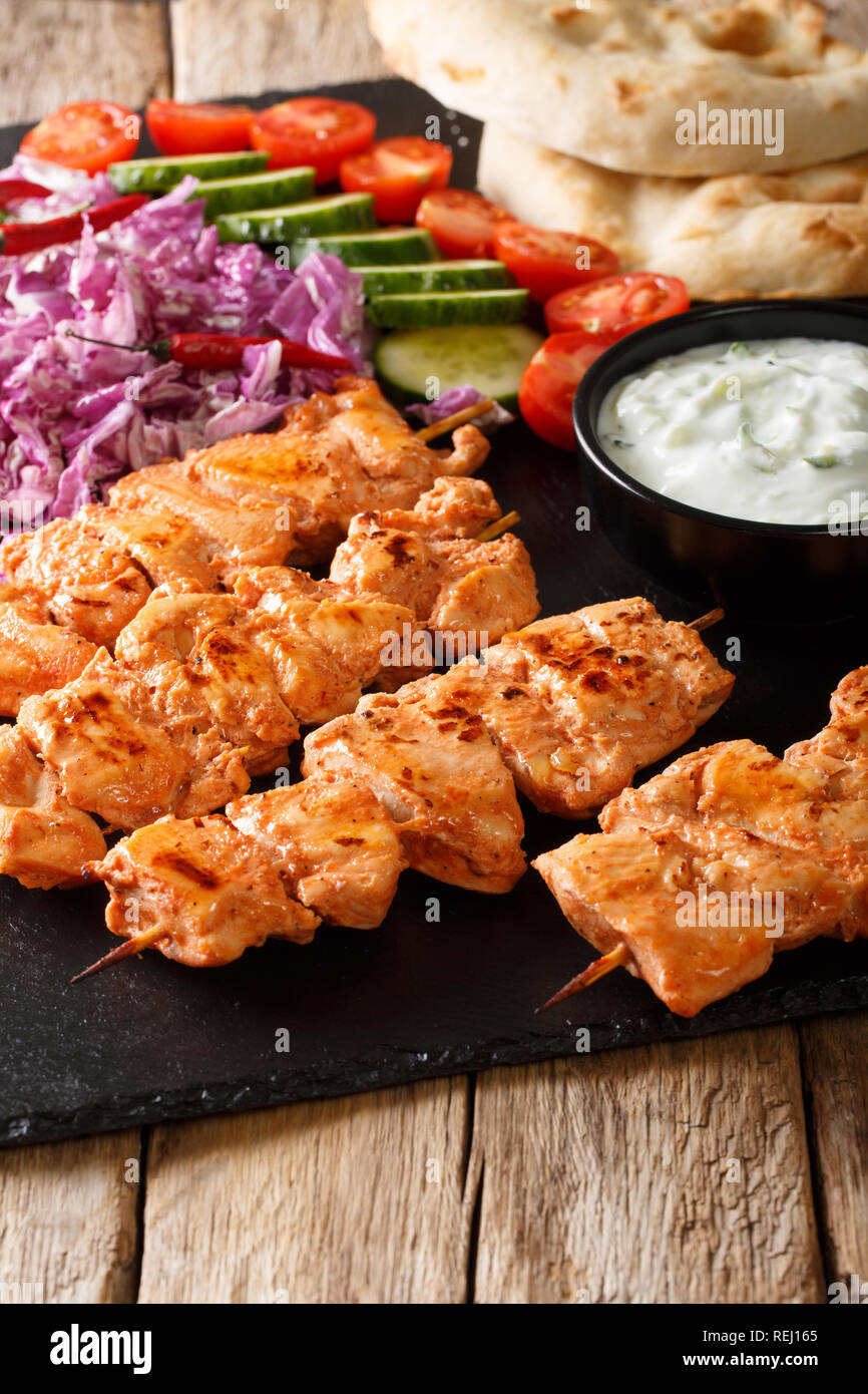Traditional Taouk chicken kebab with fresh salad, yogurt sauce and pita ...