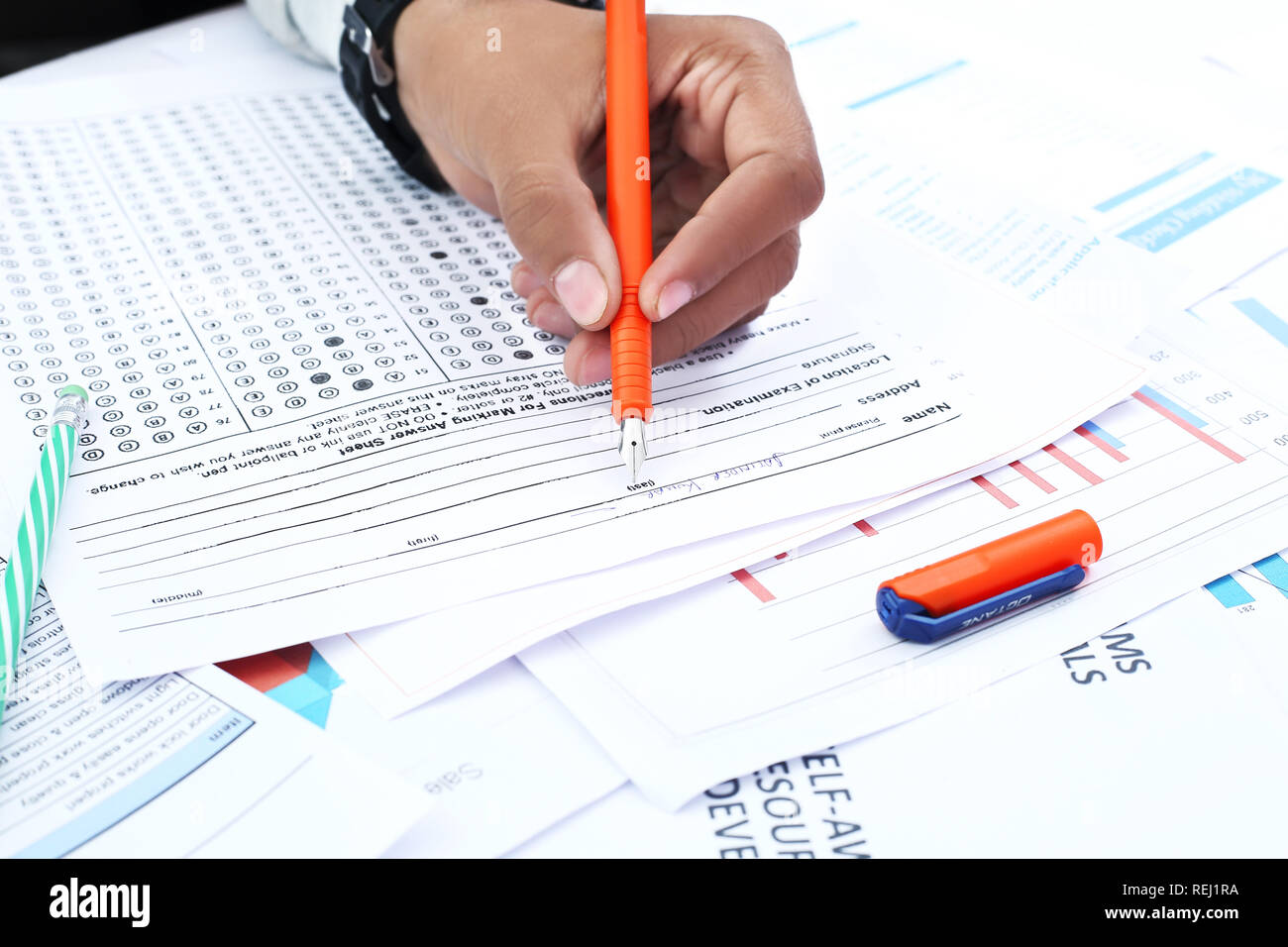 Man is filling omr sheet with pen Stock Photo - Alamy
