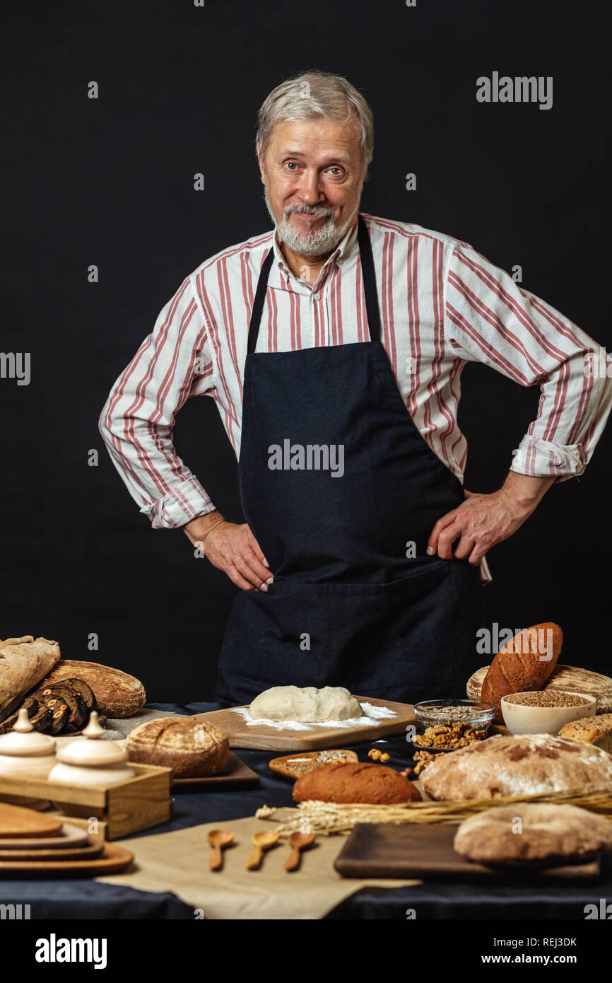 Male senior chef isolated on black background Stock Photo - Alamy