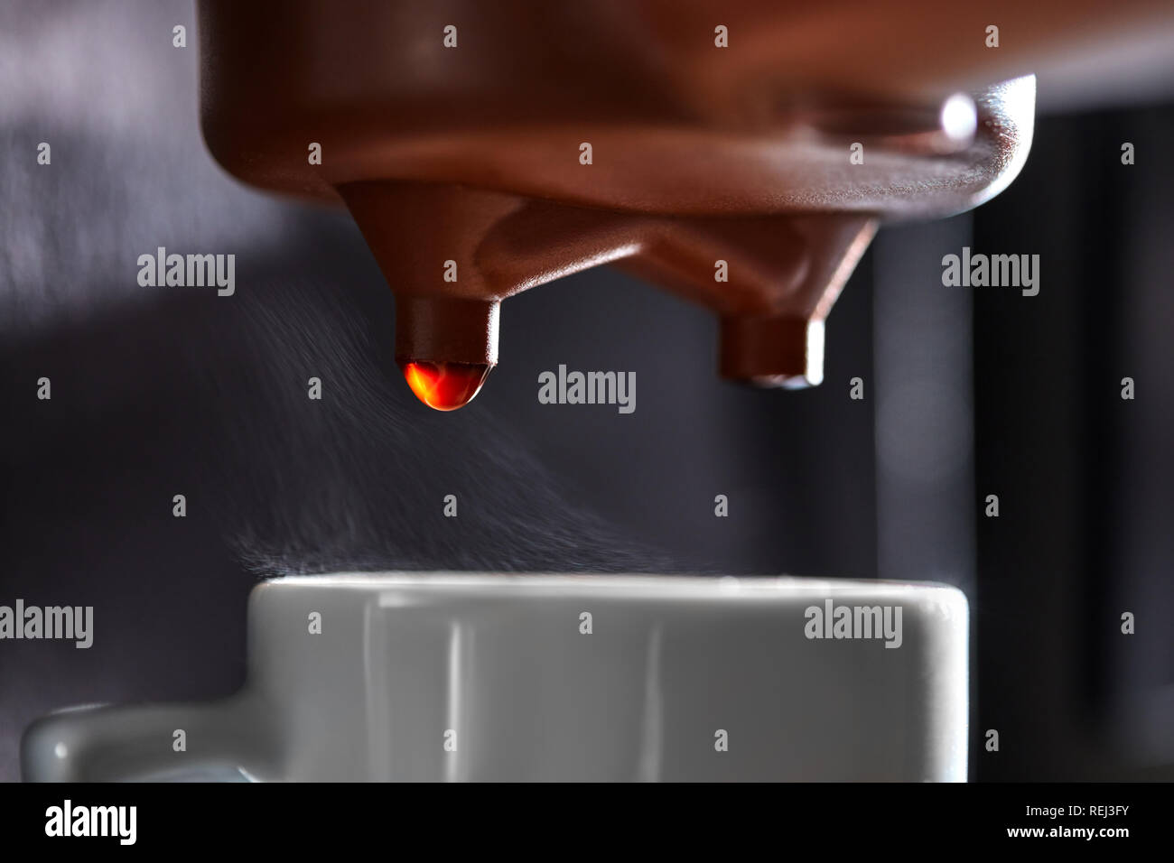 Macro photo of making coffee in the coffee machine. Drops of coffee ...