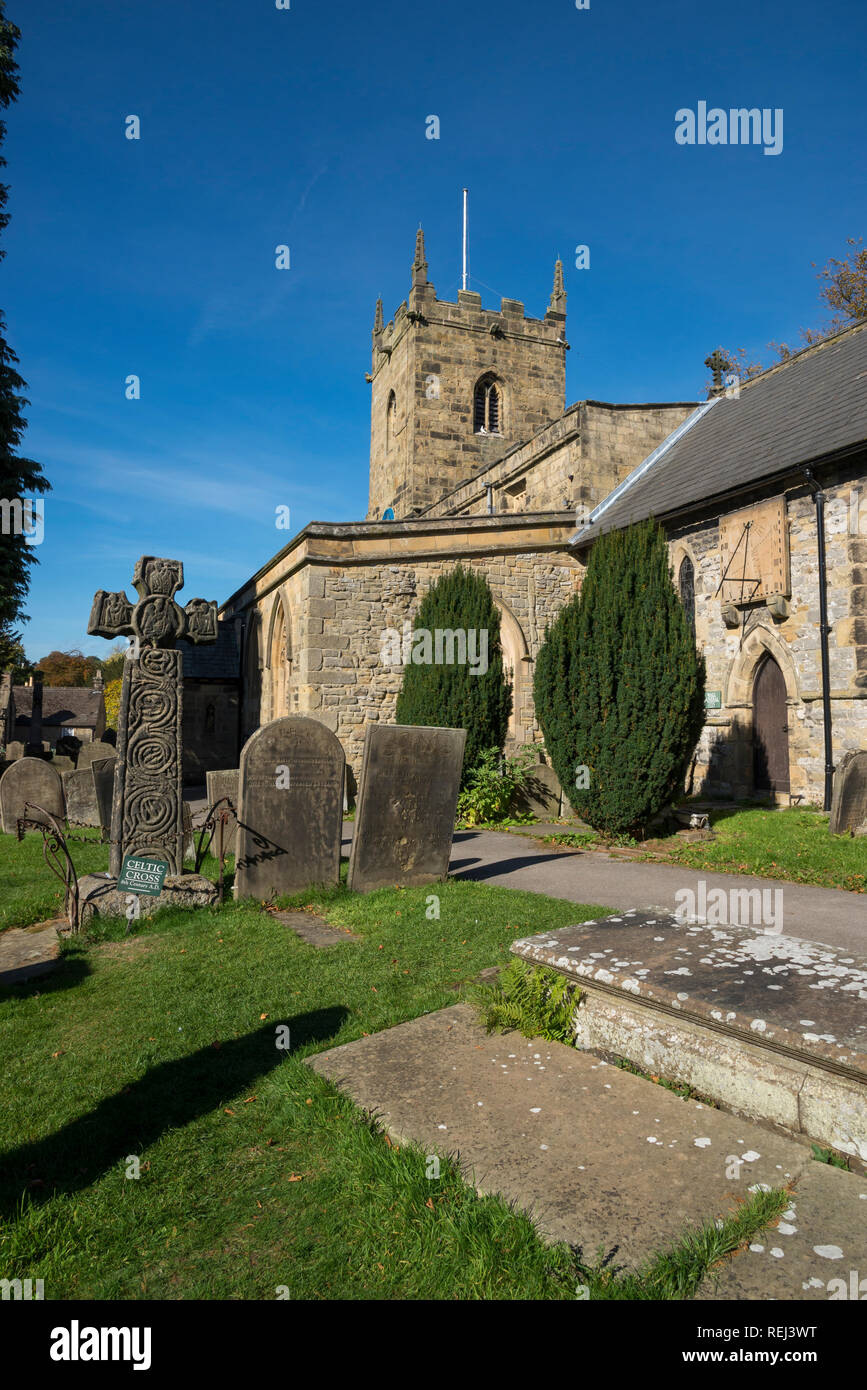 Eyam parish church and the 8th century Saxon cross in the historic ...