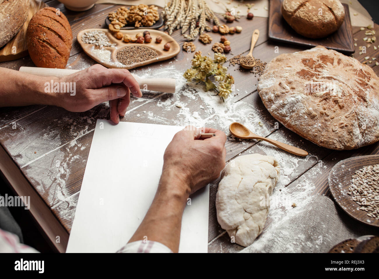 Elderly man baker cutting hi-res stock photography and images - Alamy