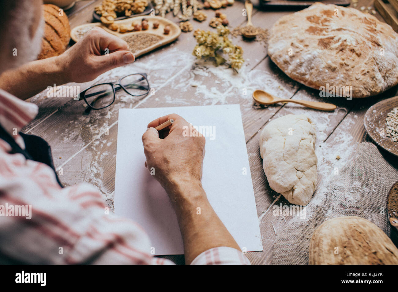 Elderly man baker cutting hi-res stock photography and images - Alamy