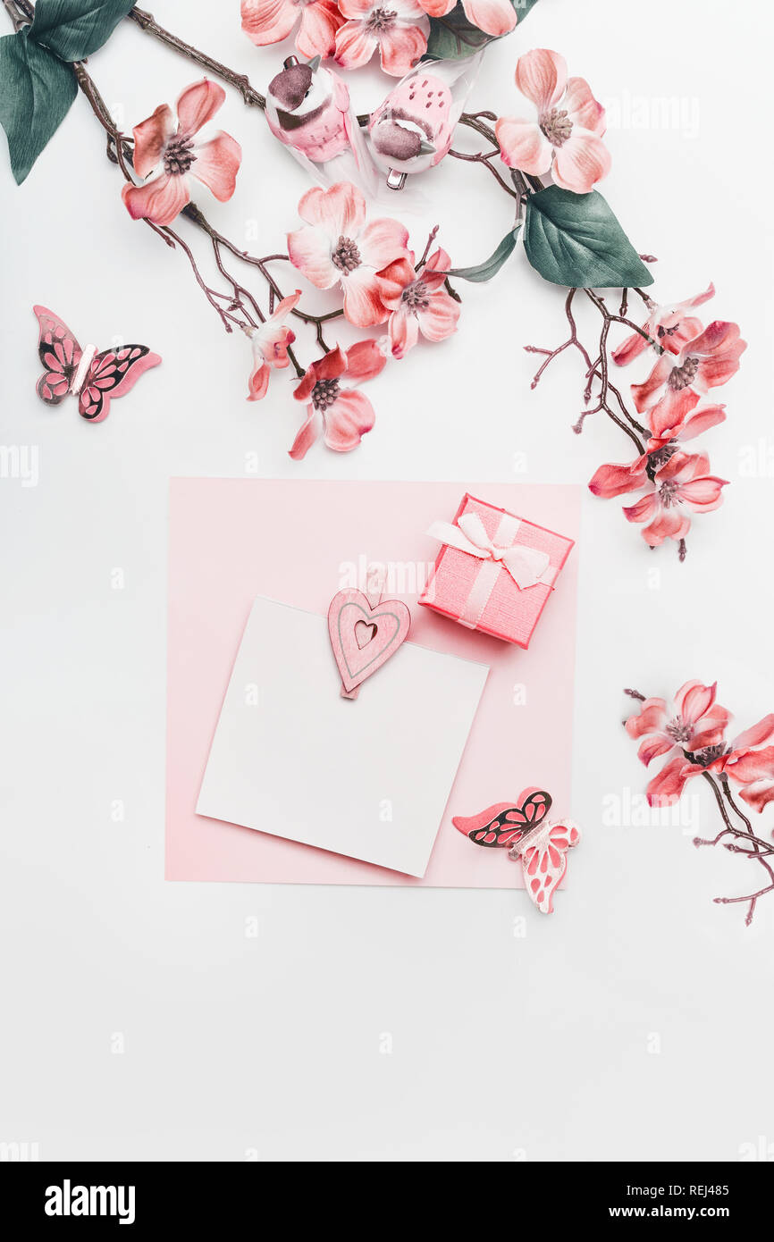 Pretty greeting card mock up in coral color with flowers, ribbon ...