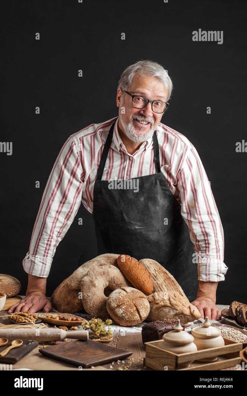 Elderly man demonstrating assortment of bakery. Homemade pastries ...