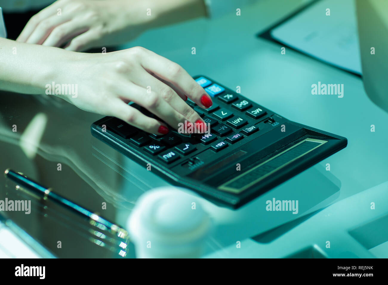 .closeup.business woman using a calculator at the workplace Stock Photo ...