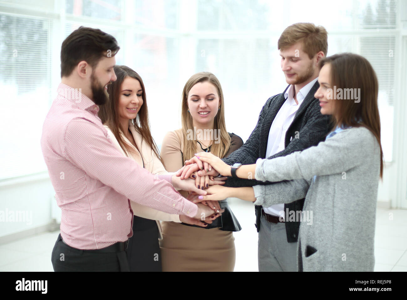 portrait of confident business team stacking hands Stock Photo - Alamy