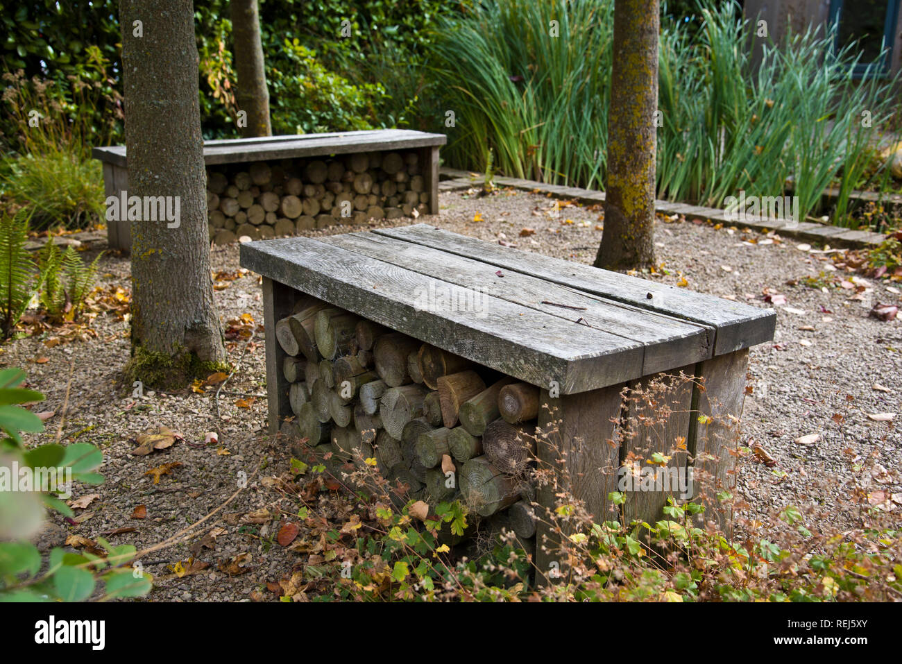 Ornate garden bench doubling as a log store Stock Photo - Alamy