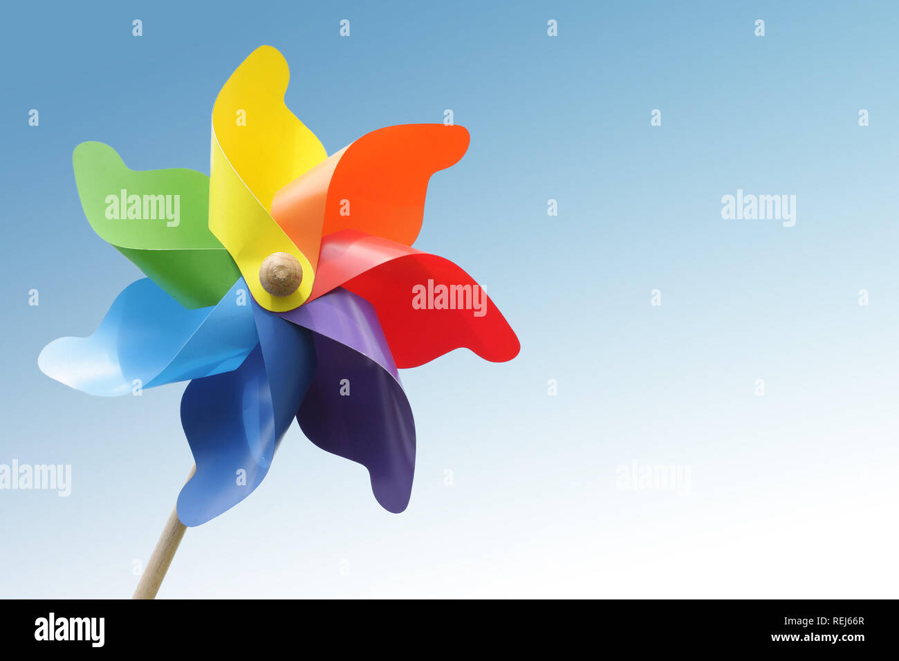 Colorful pinwheel against blue gradient background Stock Photo - Alamy
