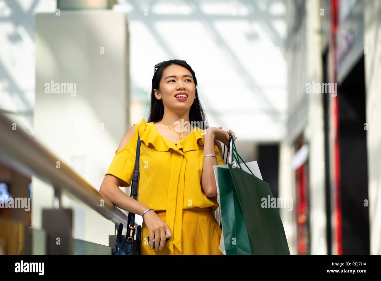 Happy Asian girl in a shopping mall Stock Photo - Alamy