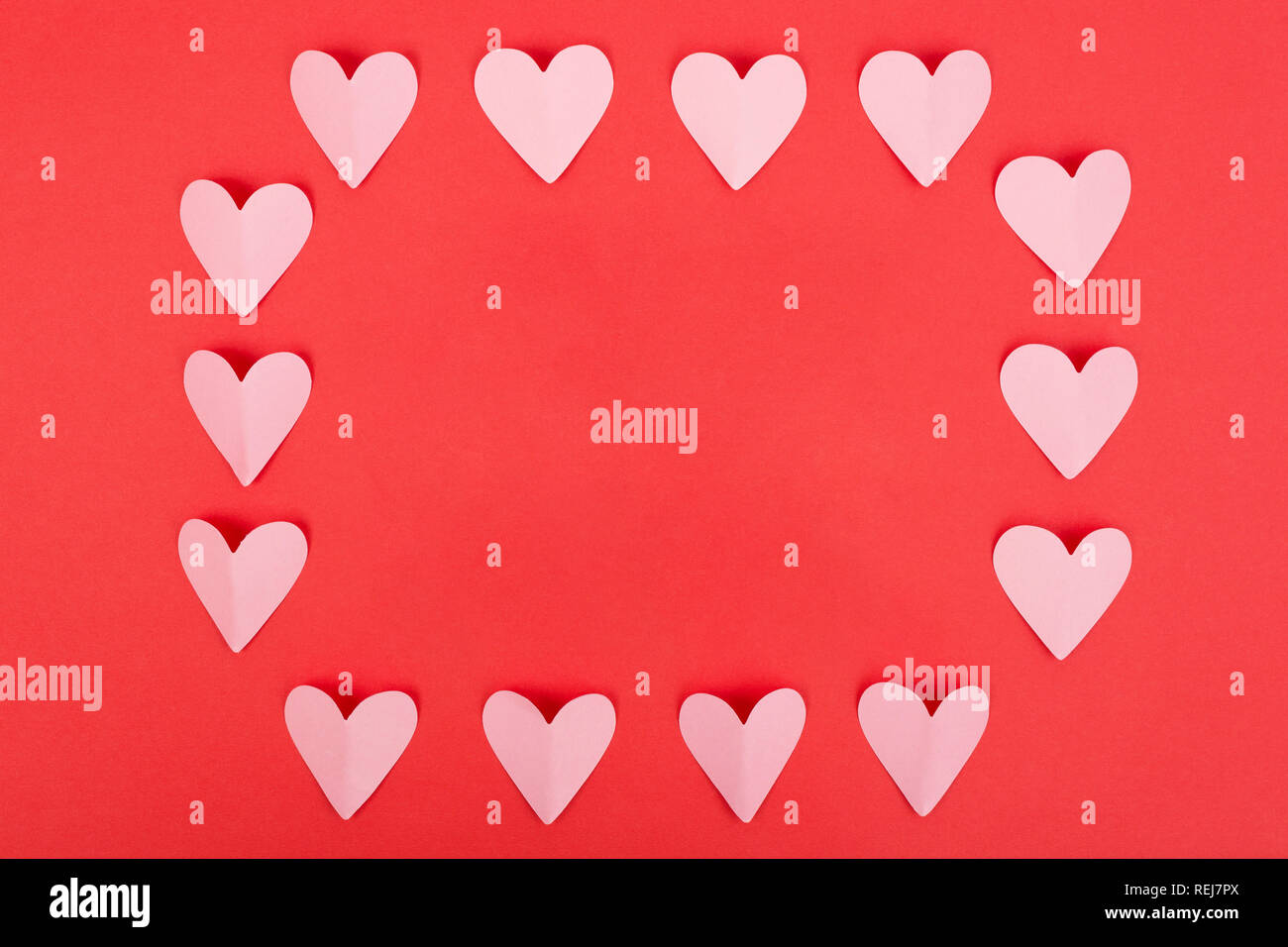 Flat lay of paper hearts frame on red background. Top view. Flat lay ...