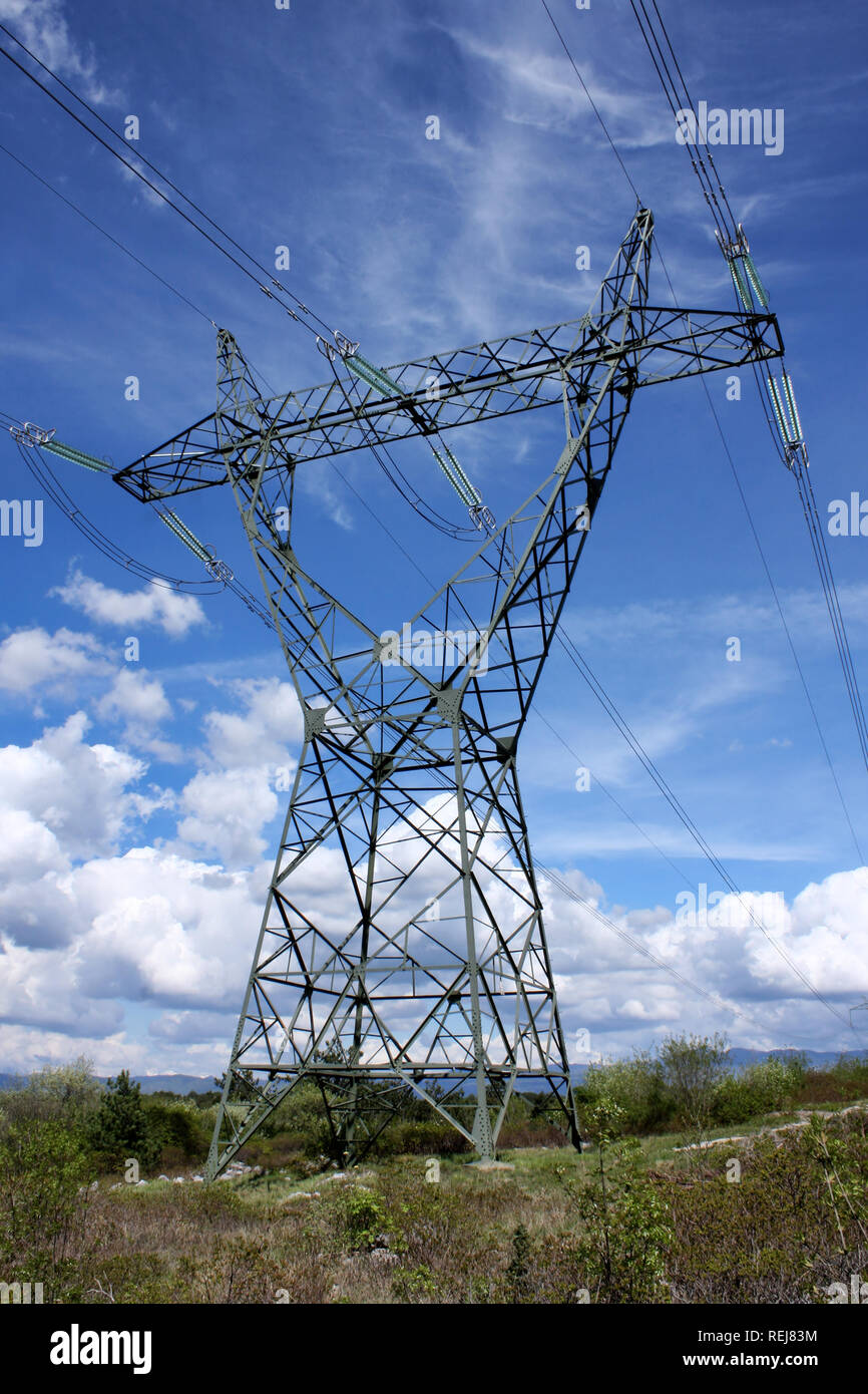 Electrical pylon against the blue sky with white clouds Stock Photo - Alamy