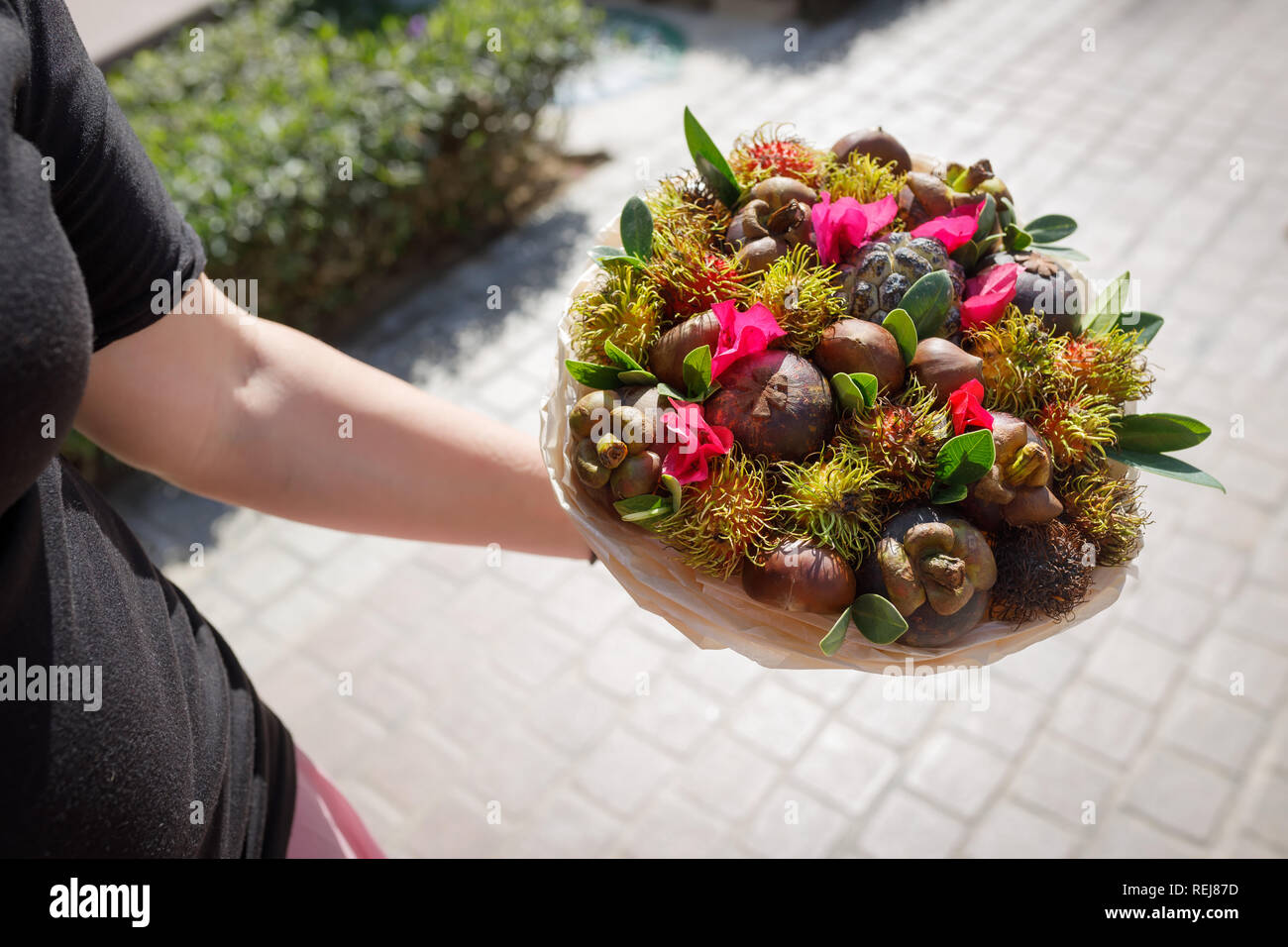 Woman holds in her hand a unique tasty bouquet of exotic fruits Stock ...