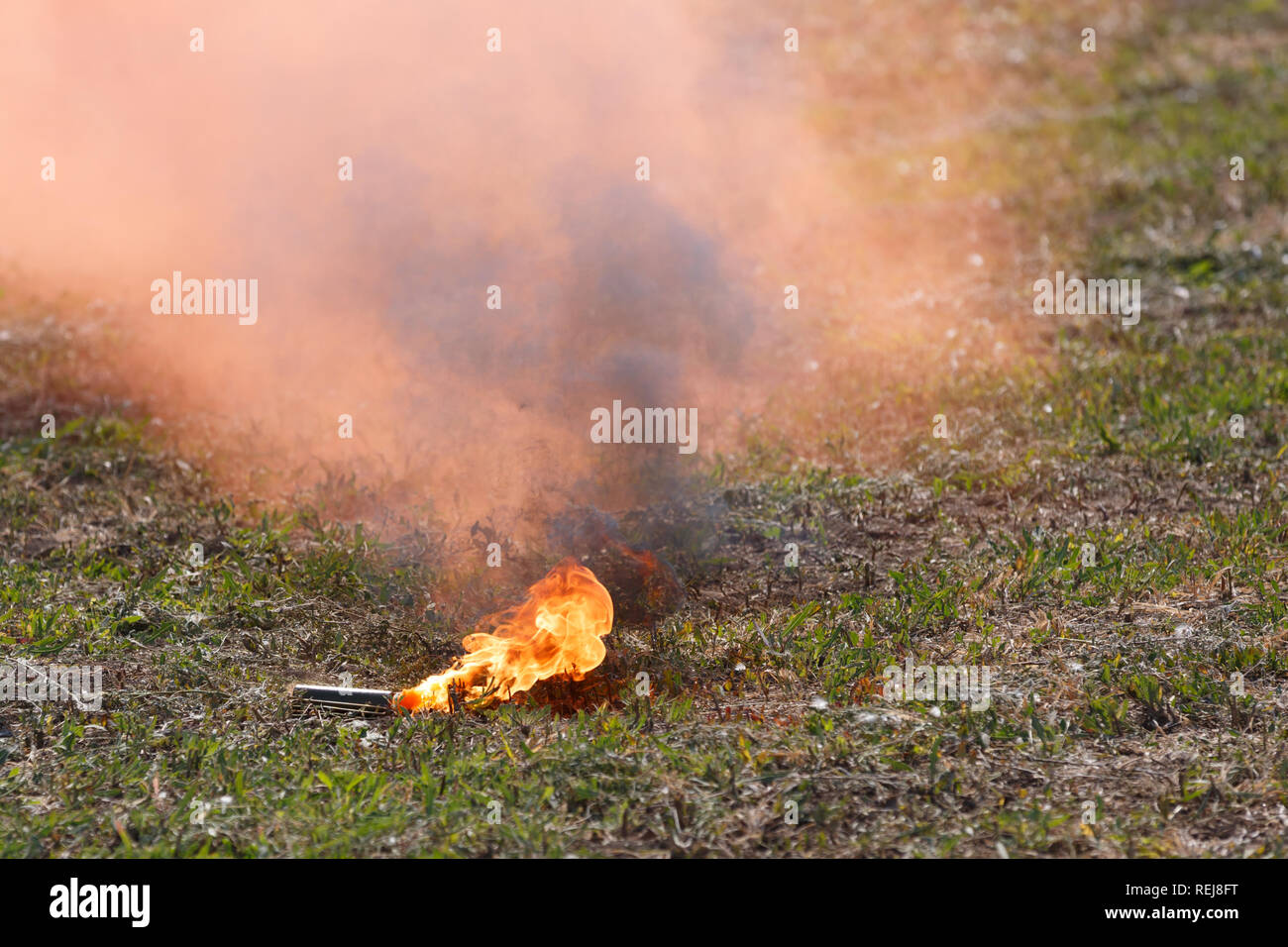 Burning smoke grenade lies on the battlefield Stock Photo - Alamy