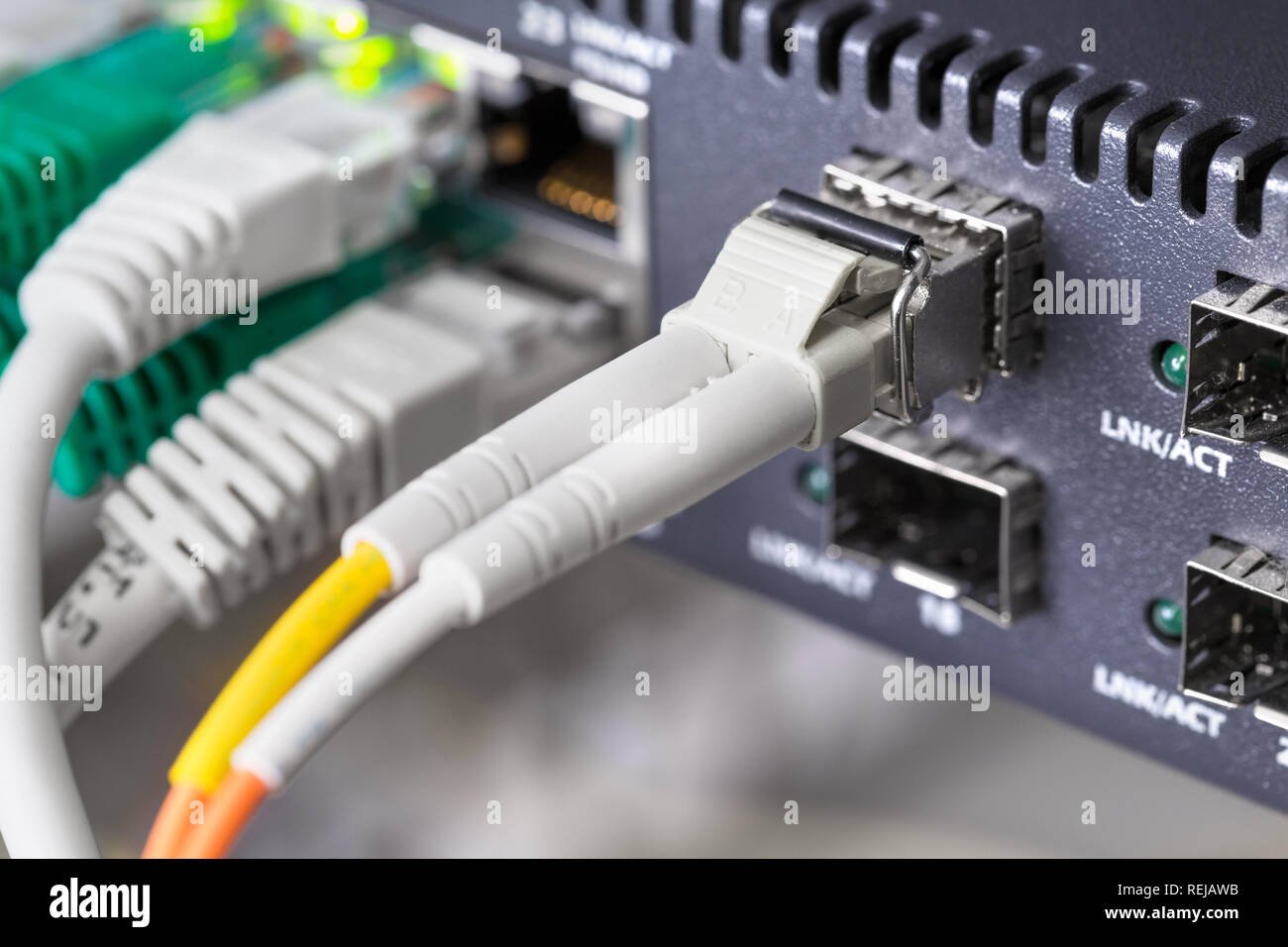 Close-up of high speed fiber network switch and cables in datacenter ...