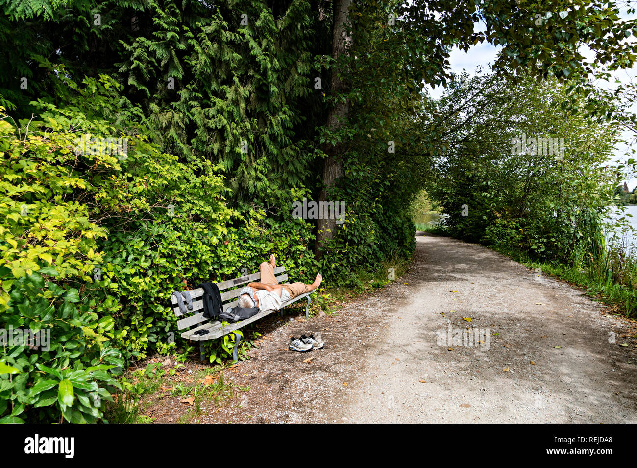Nap On The Park Bench Stock Photo - Alamy