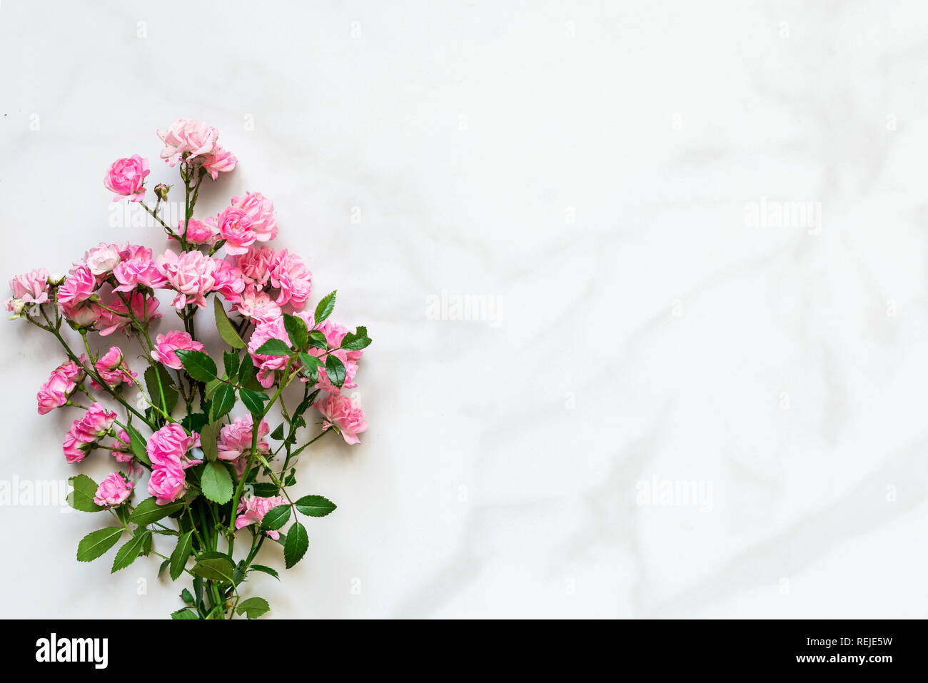 pink roses flowers bouquet over white marble table with copy space. top ...