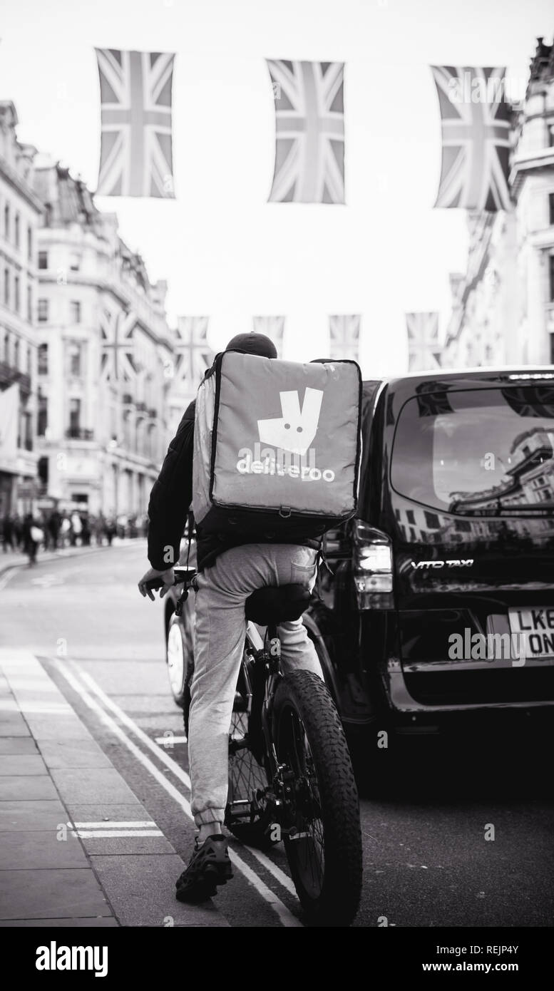 LONDON, UNITED KINGDOM - MAY 18, 2018: Deliveroo cyclist waiting at red ...