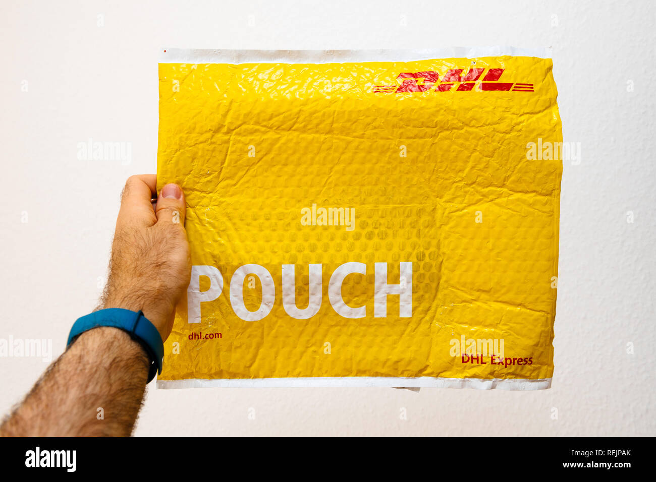 FRANKFURT, GERMANY - MAR 24, 2018: Close-up of man holding yellow DHL ...