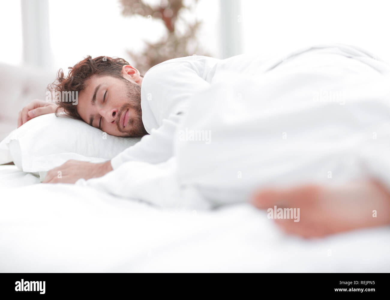closeup.the tired men sleep soundly on the bed Stock Photo - Alamy