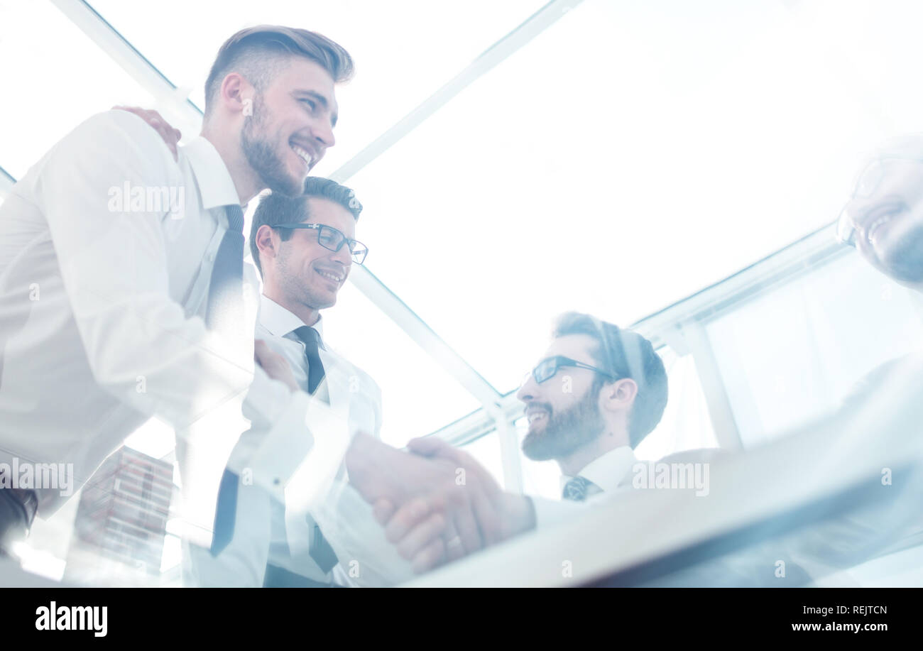 bottom view. handshake employees over the Desk Stock Photo - Alamy