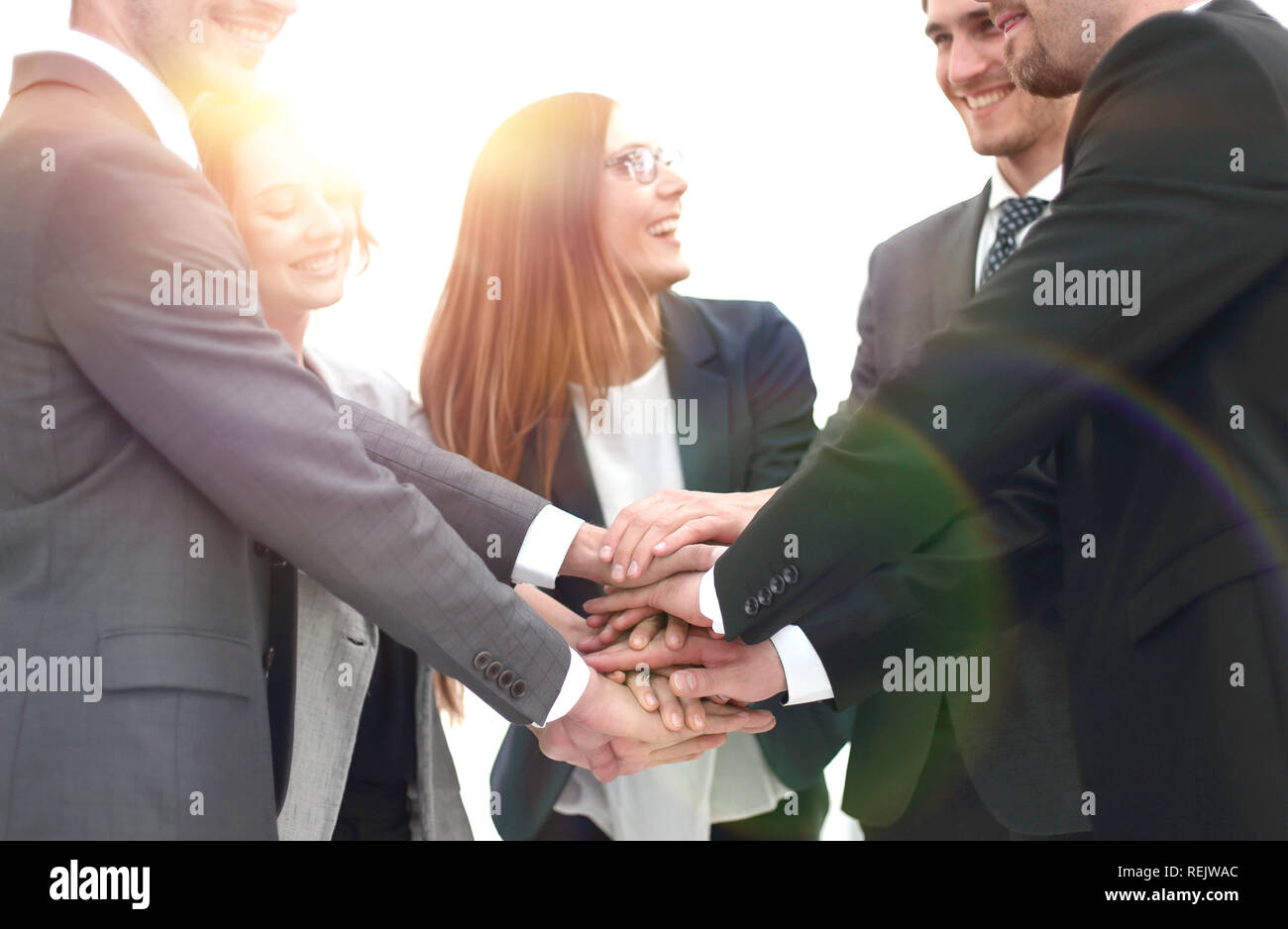 Close-up of people holding hands together while Stock Photo - Alamy