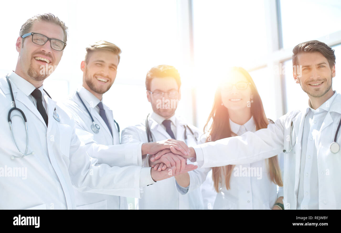 group of doctors with their hands folded together Stock Photo - Alamy