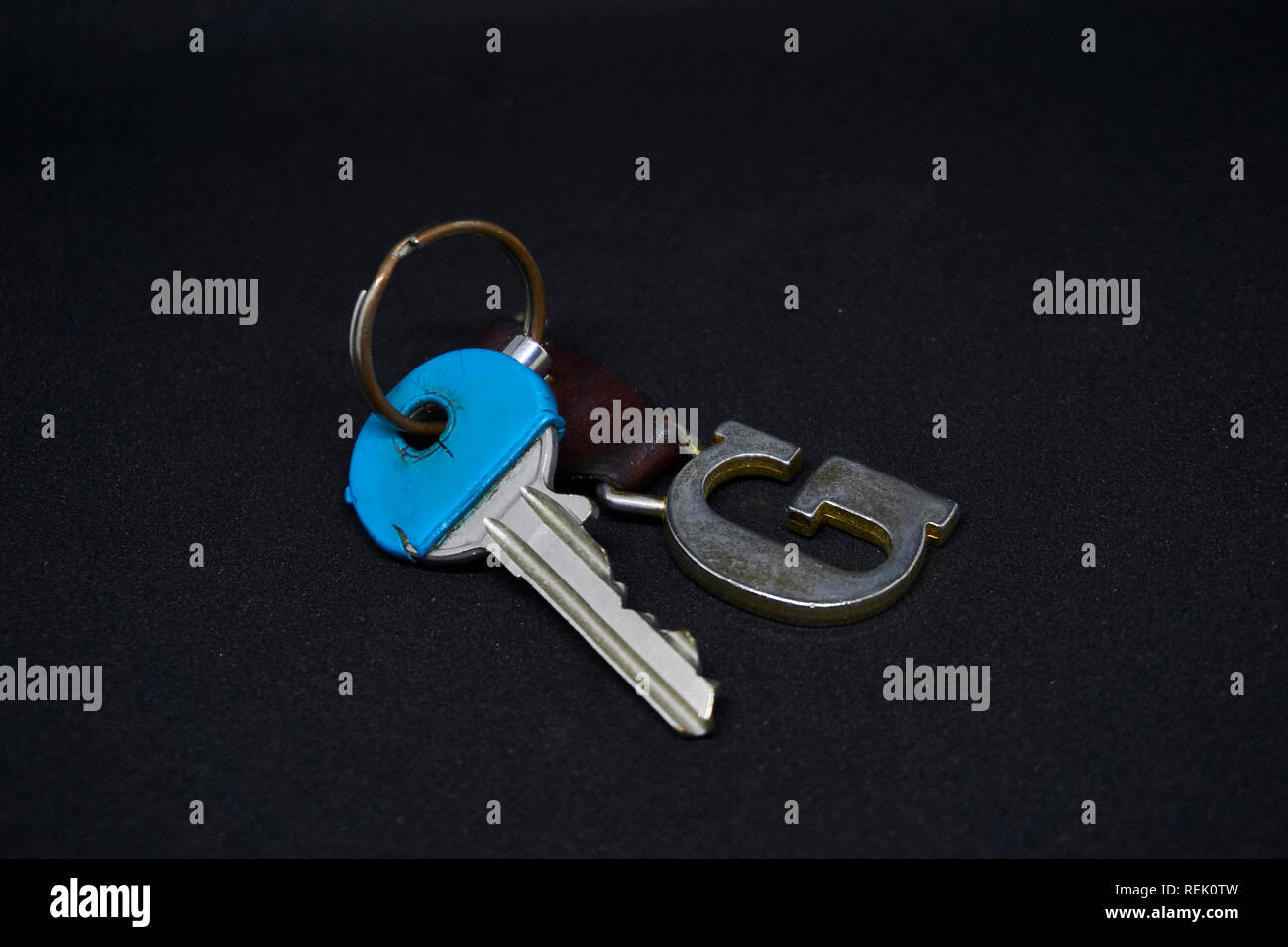 A blue key with keychains Stock Photo - Alamy