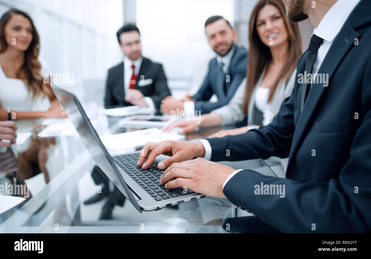 Businessman using laptop during a meeting of the Board of Directors ...