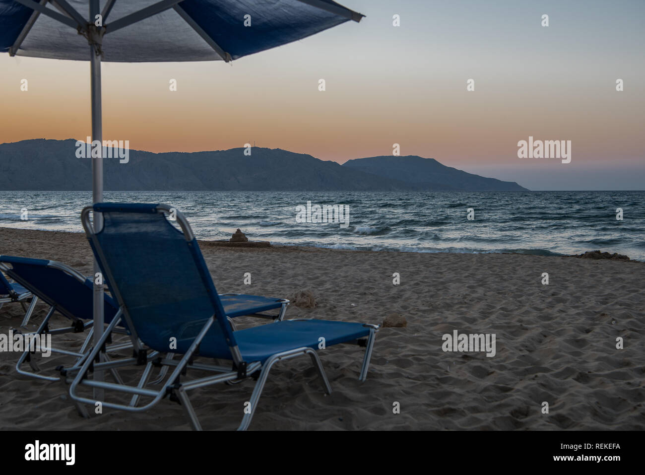Simple seating on the sunset beach Stock Photo - Alamy