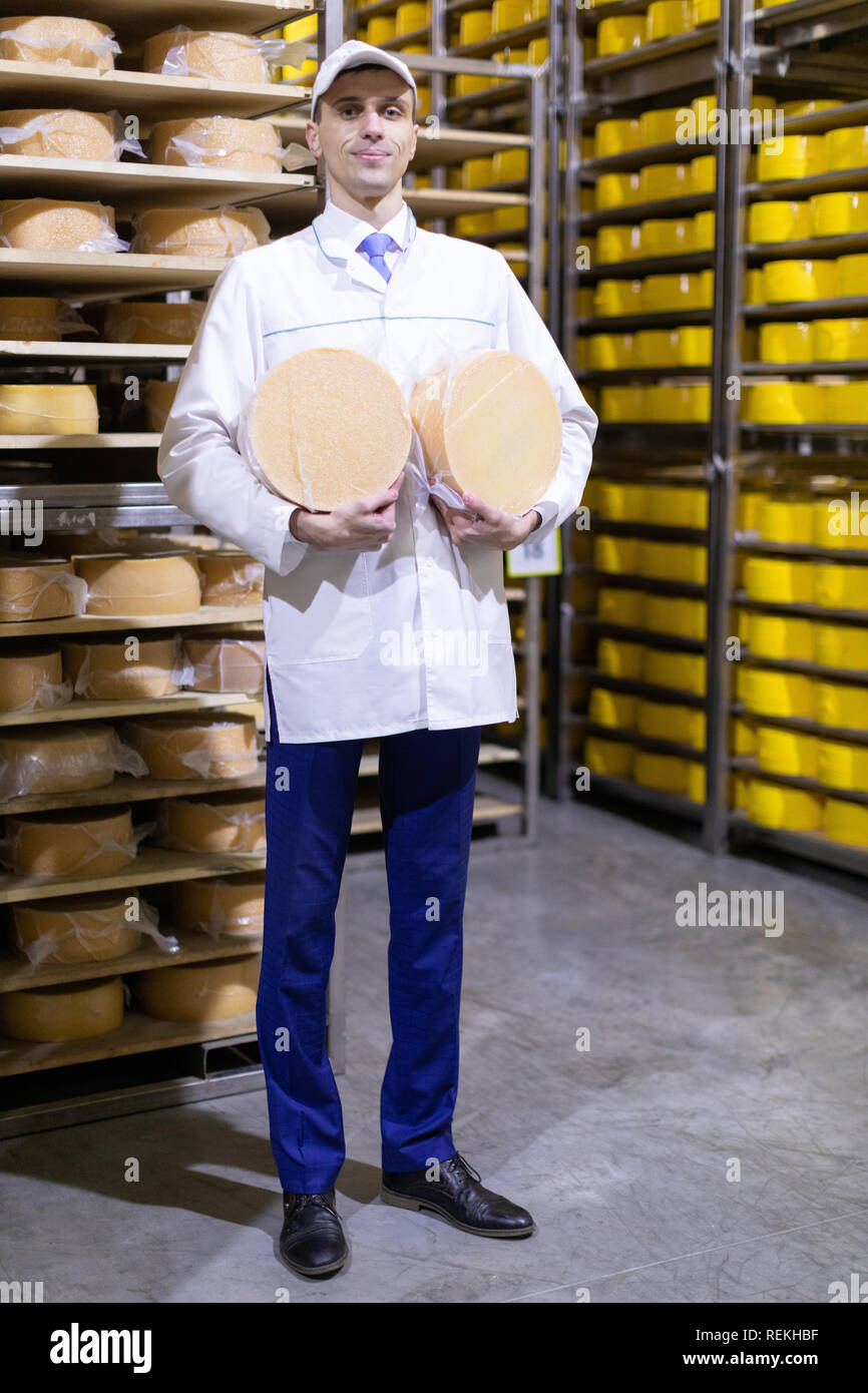 man holding a head of cheese at a dairy plant Stock Photo - Alamy