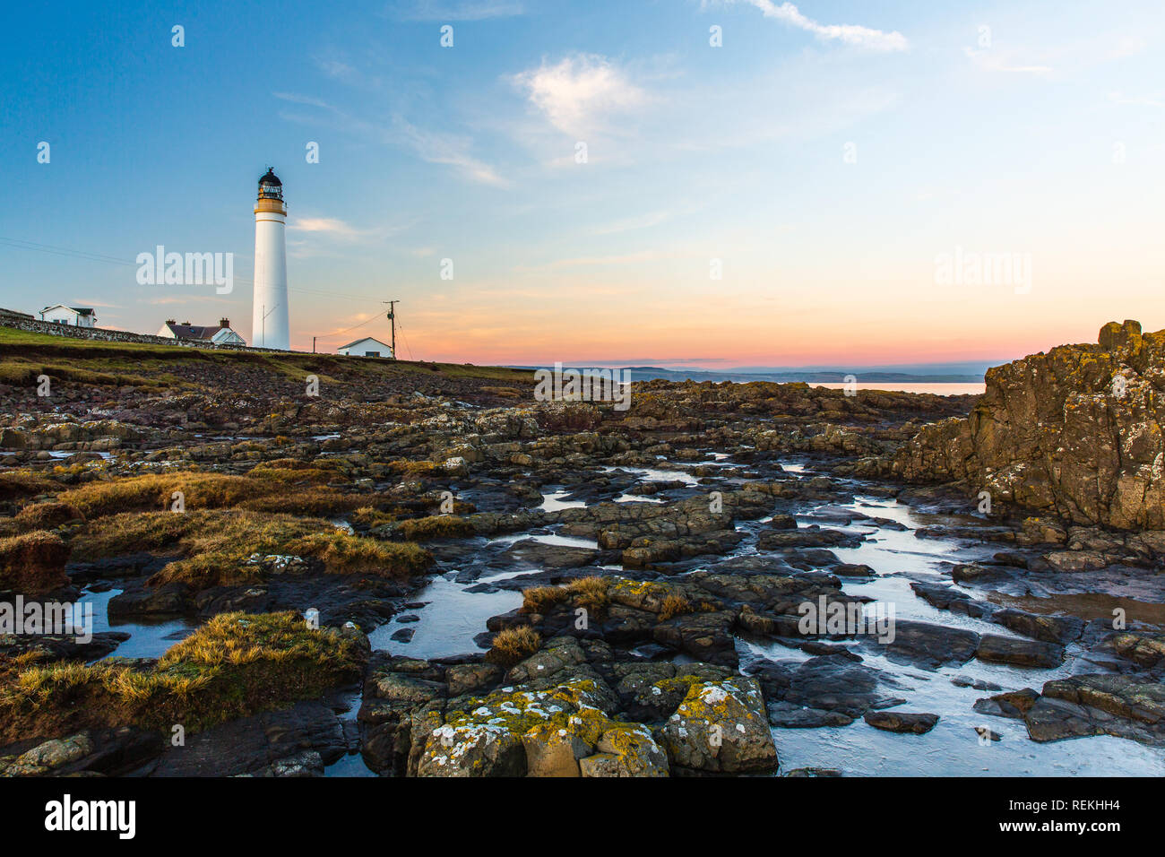 Scurdie Ness lighthouse at dusk. the lighthouse protects shipping from ...
