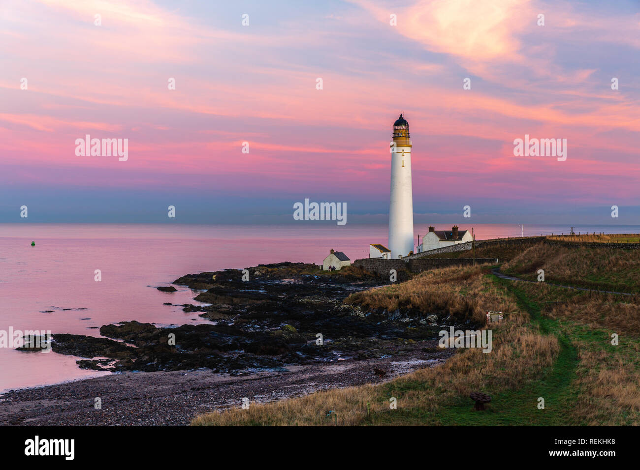 Scurdie Ness lighthouse at dusk. the lighthouse protects shipping from ...