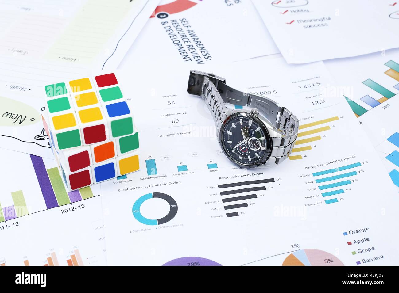 Picture of Rubik's cube and wrist watch on the financial paper Stock ...