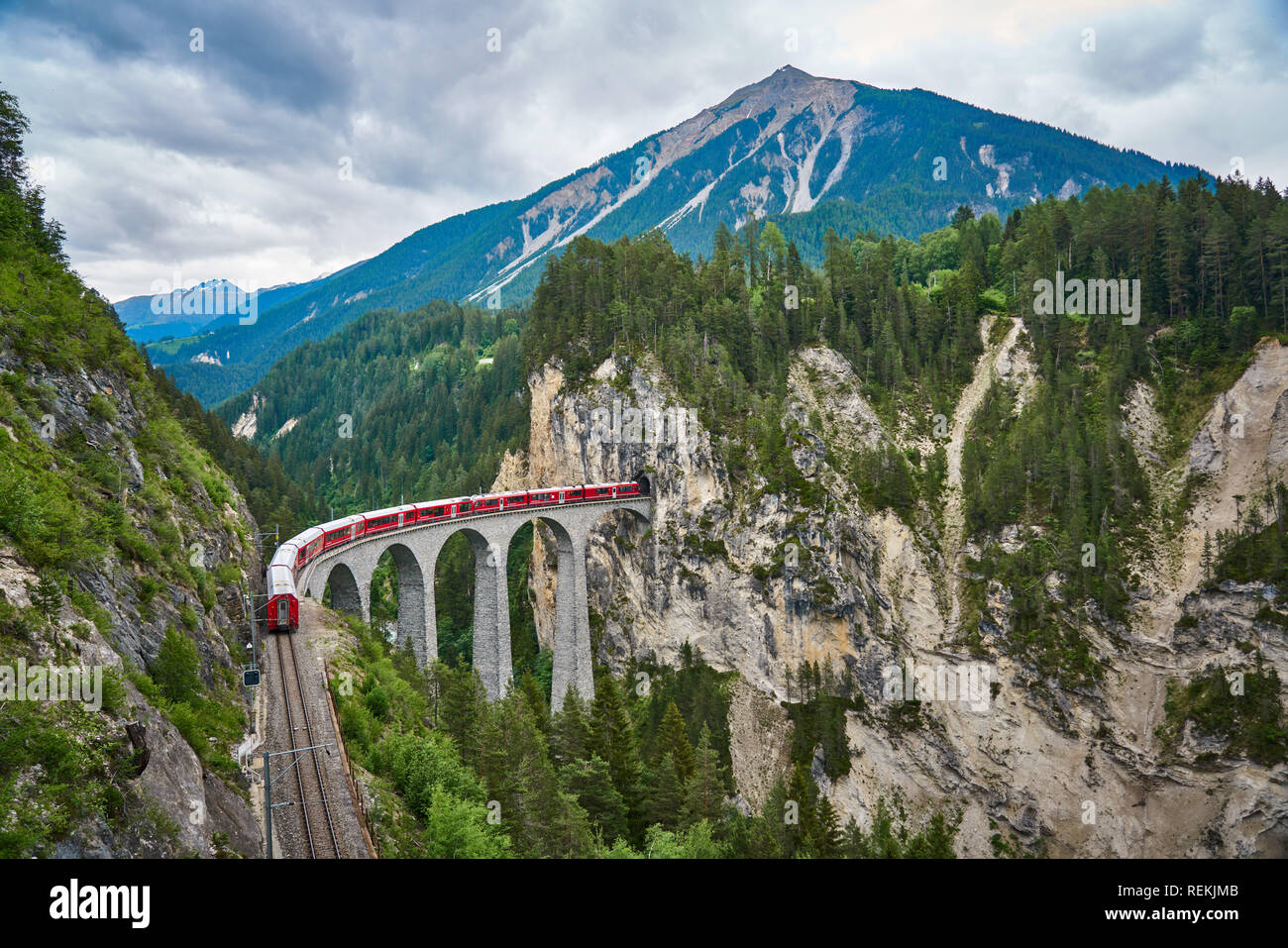 Red train passes above the Landwasser Viaduct bridge, in canton of ...