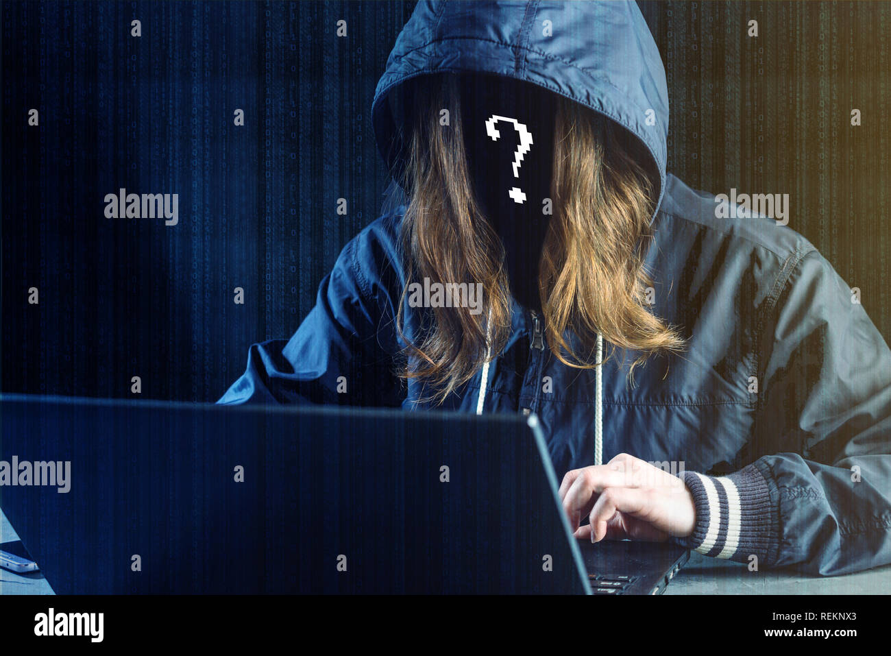 Anonymous girl hacker programmer uses a laptop to hack the system. Stealing personal data ...