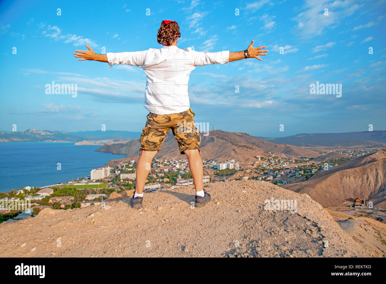 A man overlooking a panoramic view of a beautiful coastline Stock Photo ...
