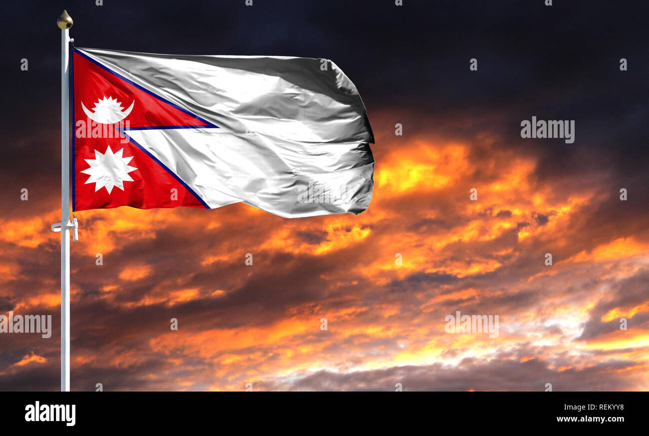 flag of Nepal on flagpole fluttering in the wind against a colorful ...