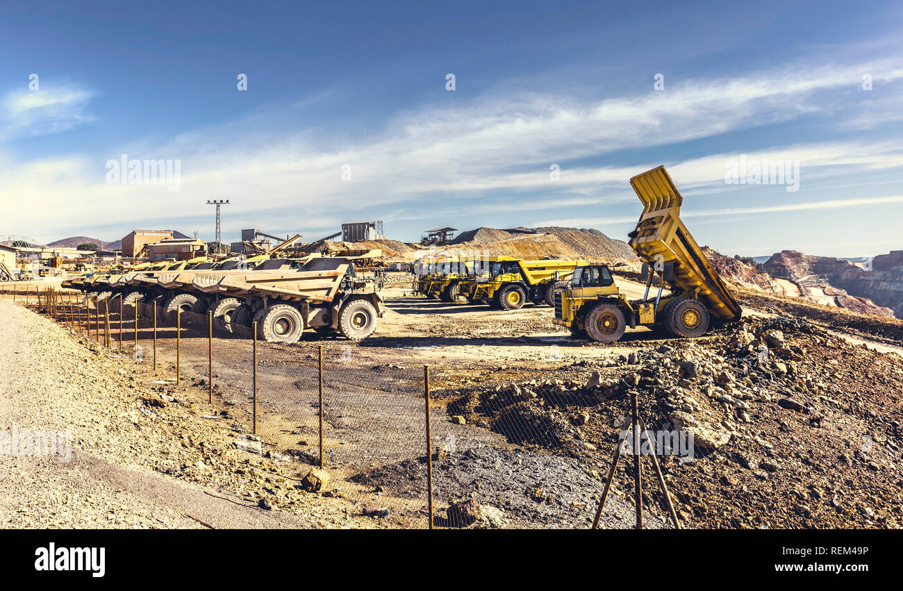 Dumper truck tilting the ore load in the open pit mine of Riotinto ...