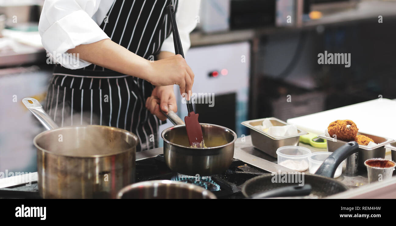 Chef cooking food in the kitchen, Chef preparing food Stock Photo - Alamy