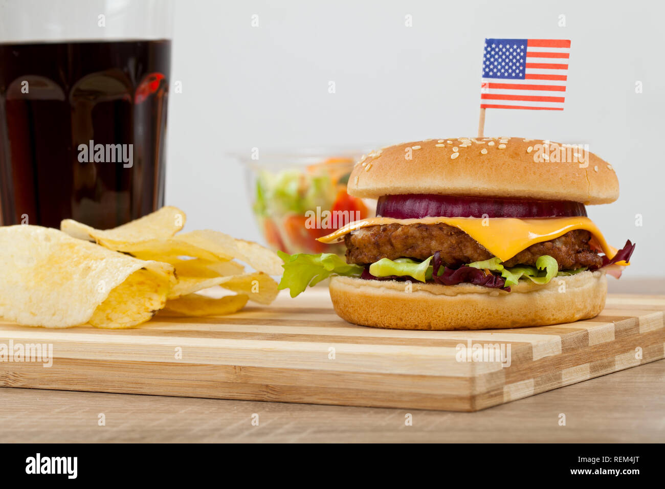 Delicious cheeseburger with beef, cheddar and lettuce, a side of potato ...