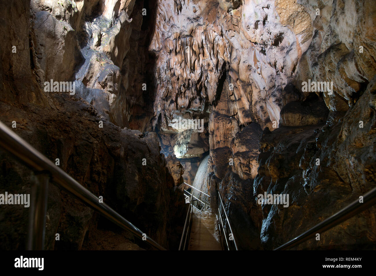 Touristic cave underground with railing, wooden bridges and light ...