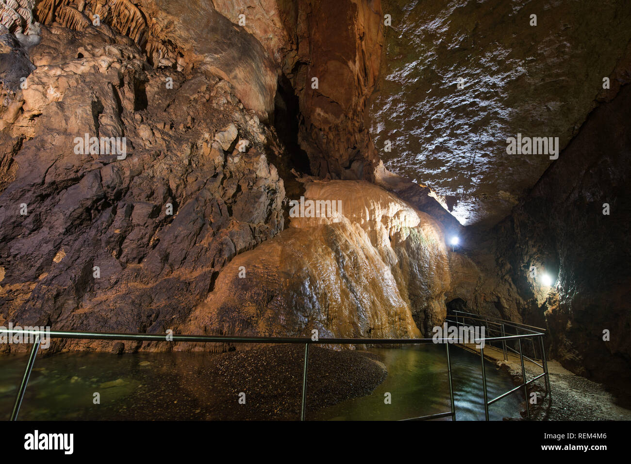 Touristic cave underground with railing, wooden bridges and light ...
