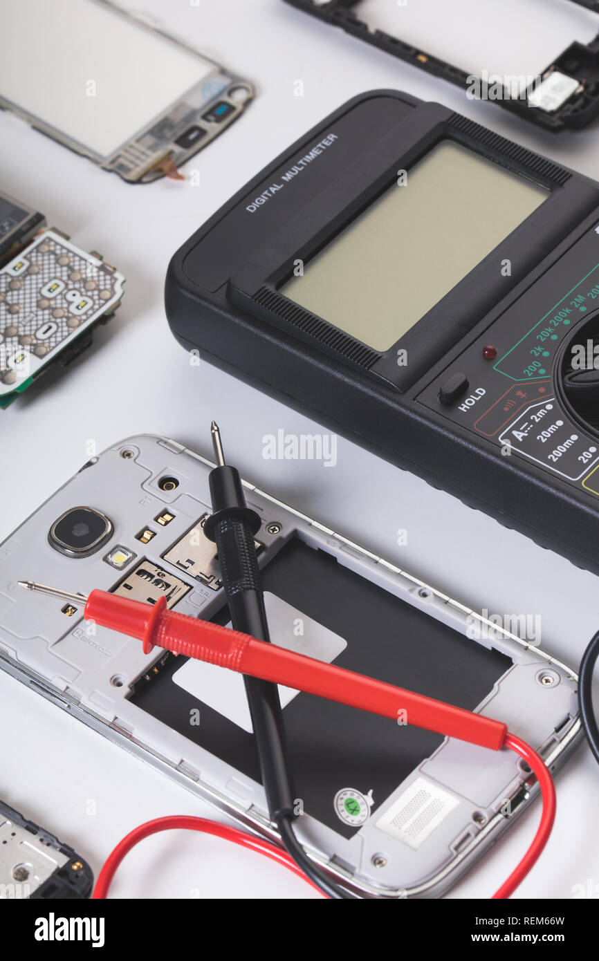 disassembled mobile phone and tools on white background Stock Photo - Alamy