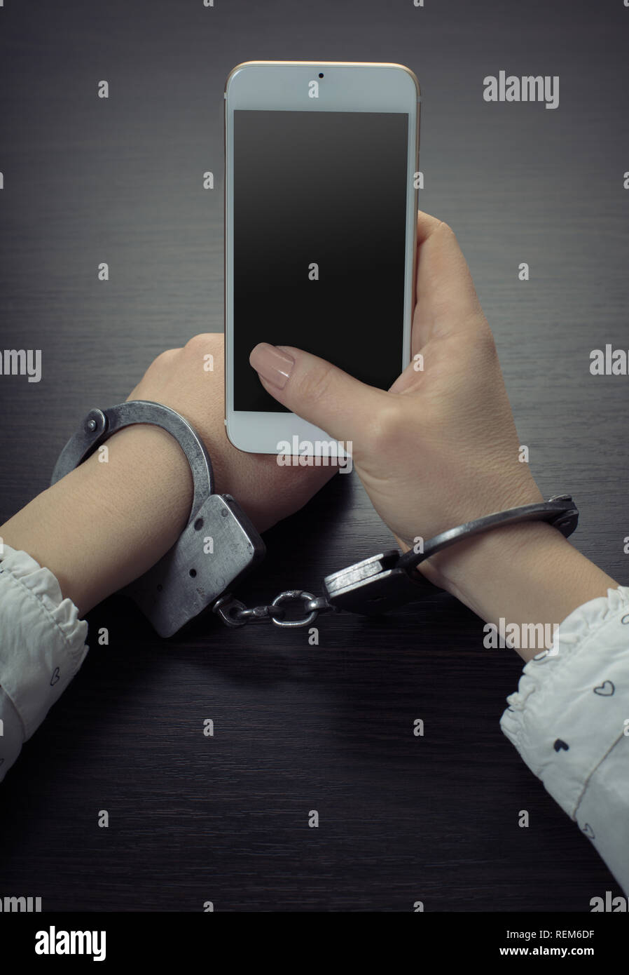 Hands handcuffs phone hi-res stock photography and images - Alamy