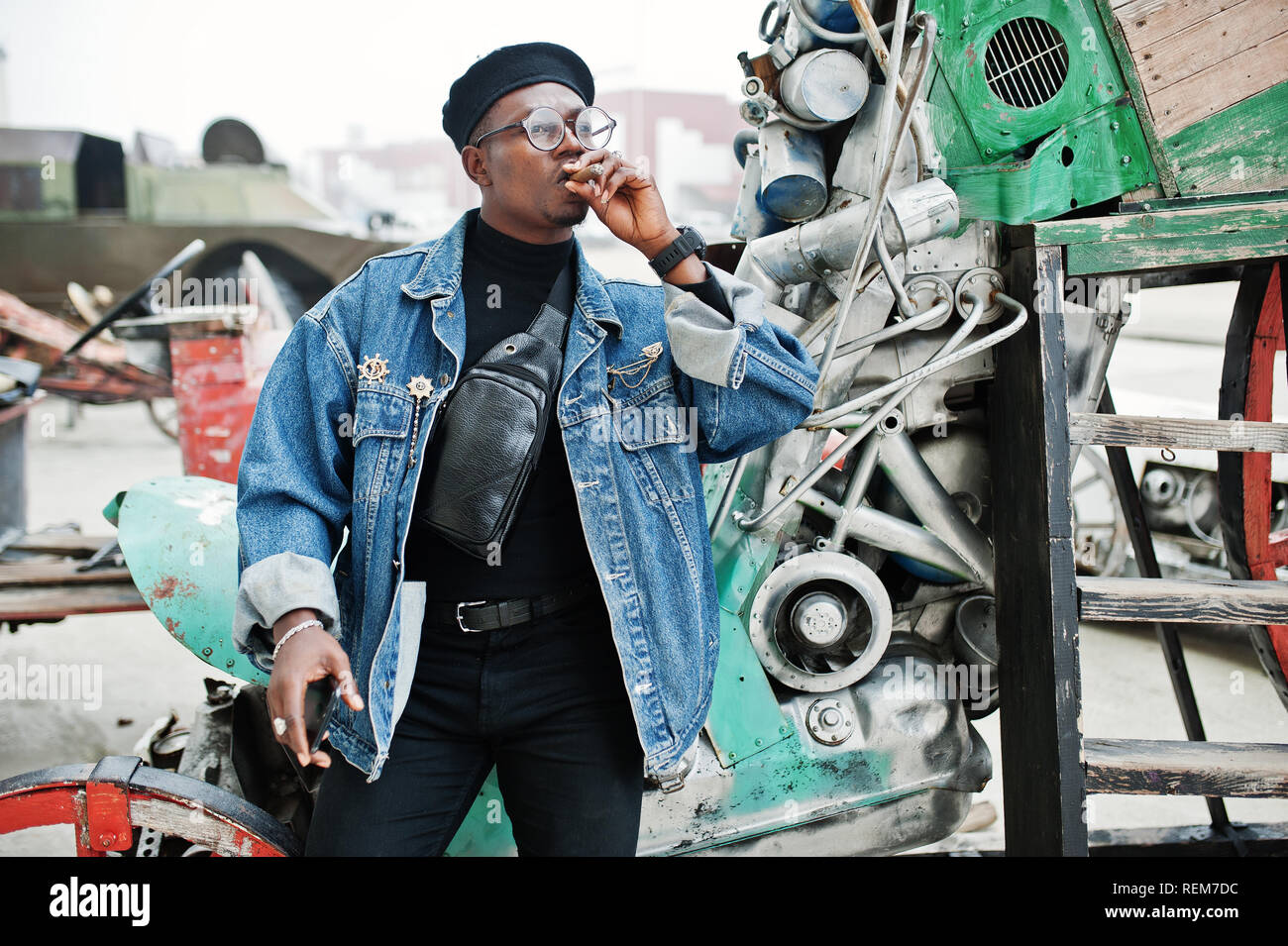 African american man in jeans jacket, beret and eyeglasses, smoking ...