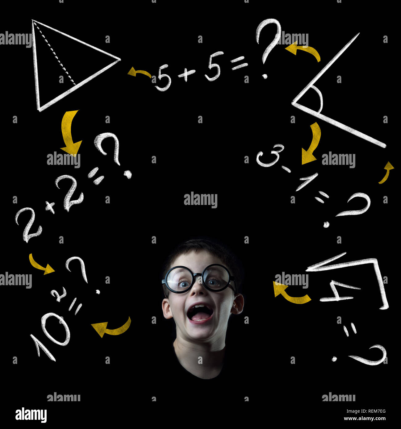 boy solve mathematics examples at the blackboard on black background ...