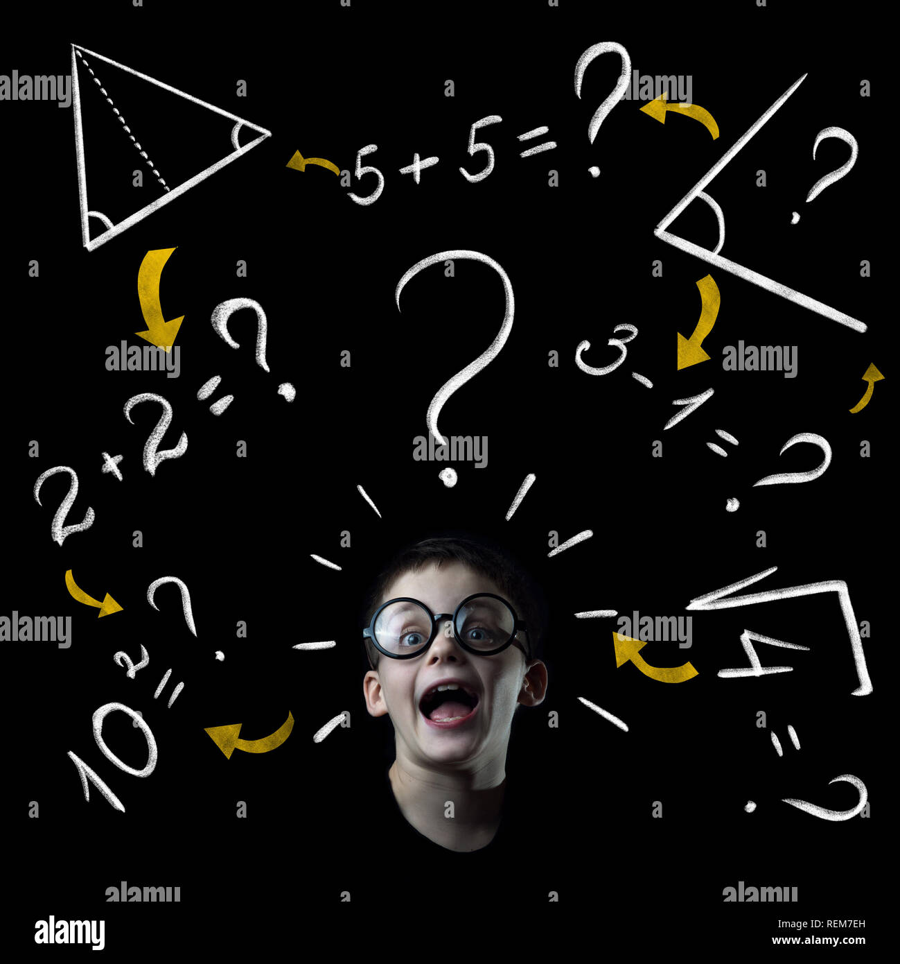 boy solve mathematics examples at the blackboard on black background ...