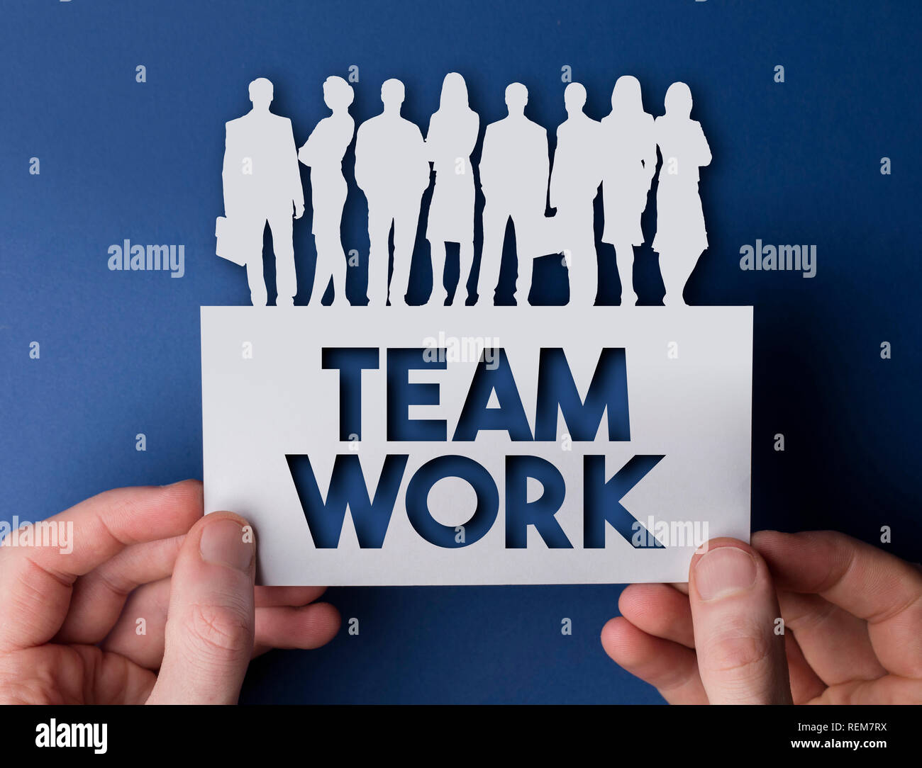 Hands holding a teamwork business people white sign Stock Photo - Alamy