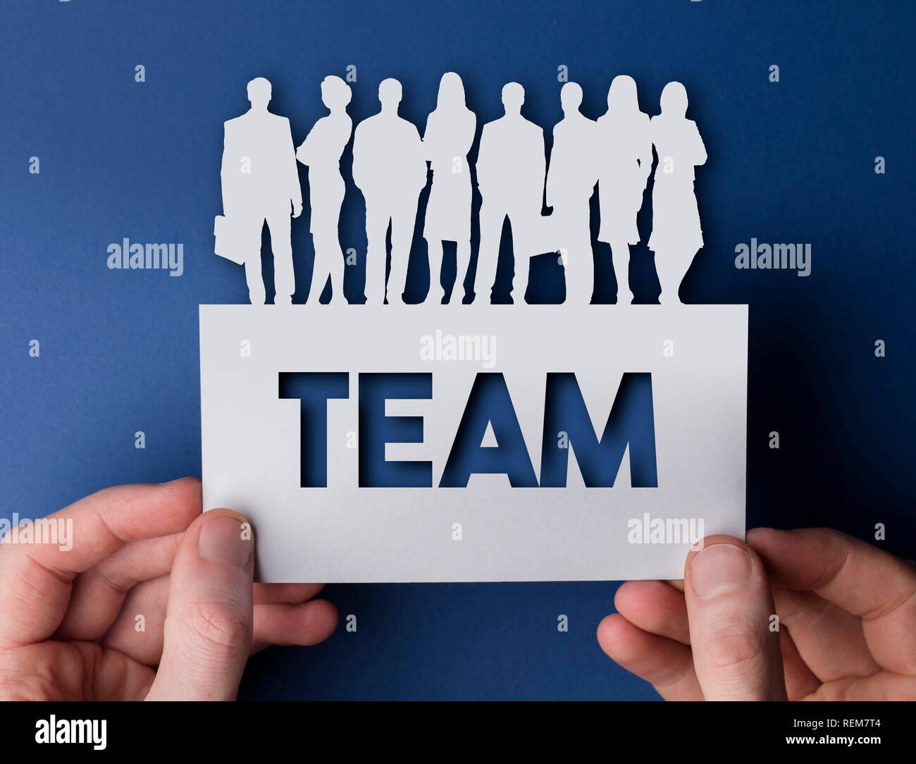 Hands holding a team business people white sign Stock Photo - Alamy